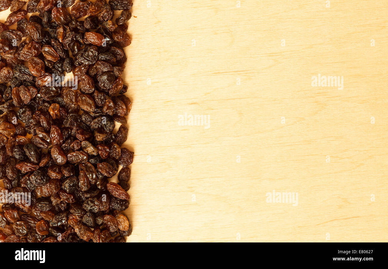 Healthy food organic nutrition. Border frame of raisin on wooden table ...