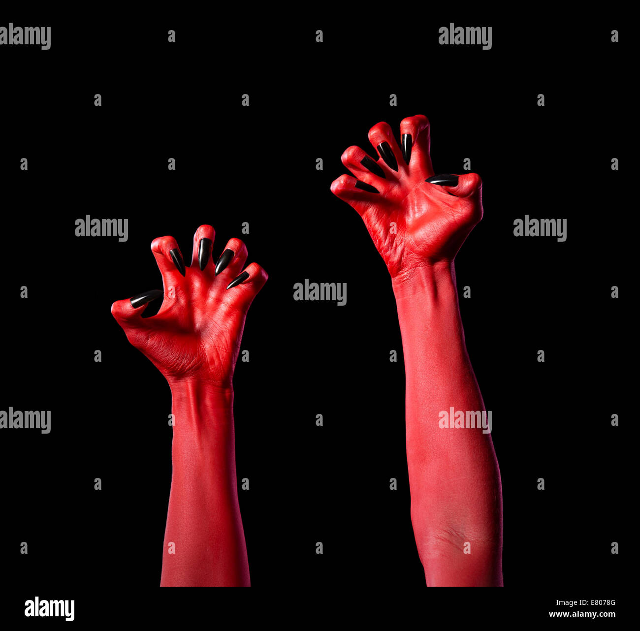 Red devil hands with black nails, Halloween theme, isolated on black ...
