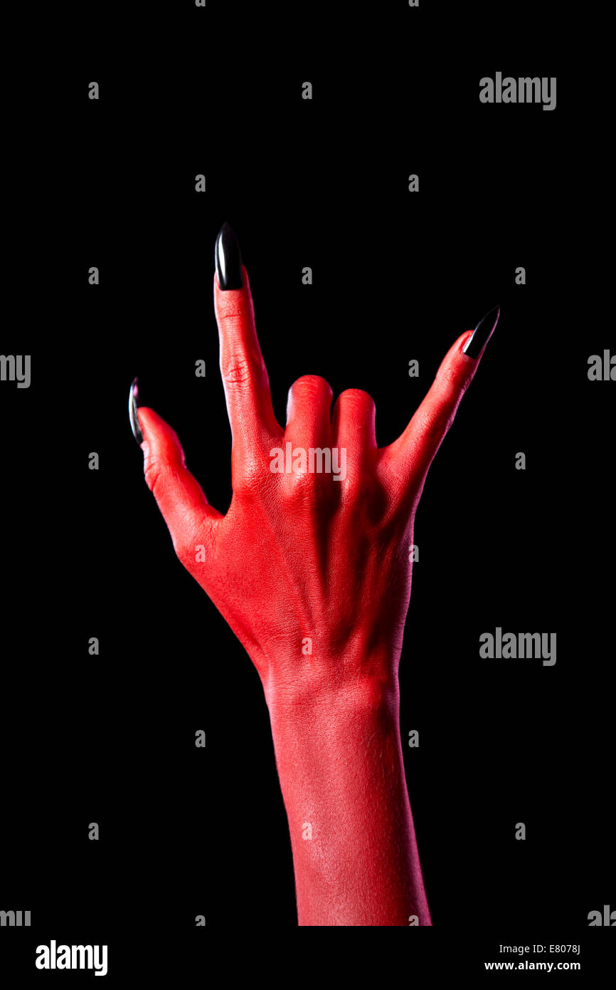 Devil hand showing heavy metal gesture, isolated on black background ...