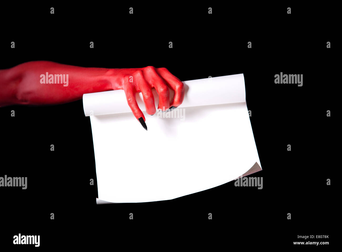 Red devil hand holding paper scroll, Halloween deal with devil concept ...