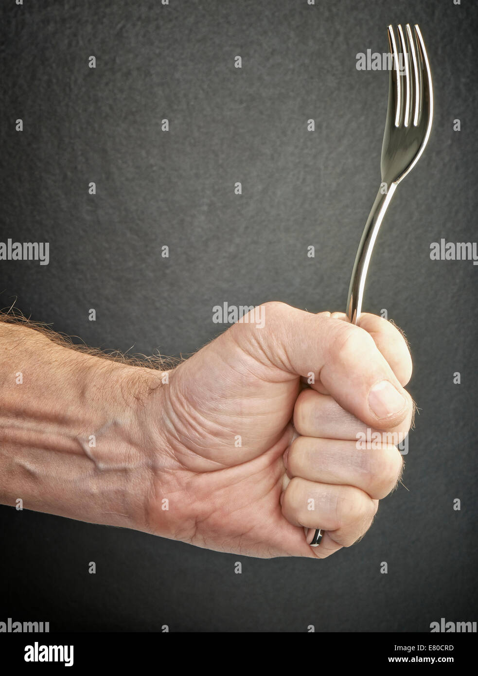 hungry and angry male hand at restaurant holding fork Stock Photo - Alamy