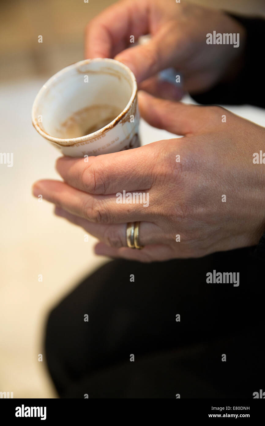 greek woman reading coffee grounds Stock Photo - Alamy