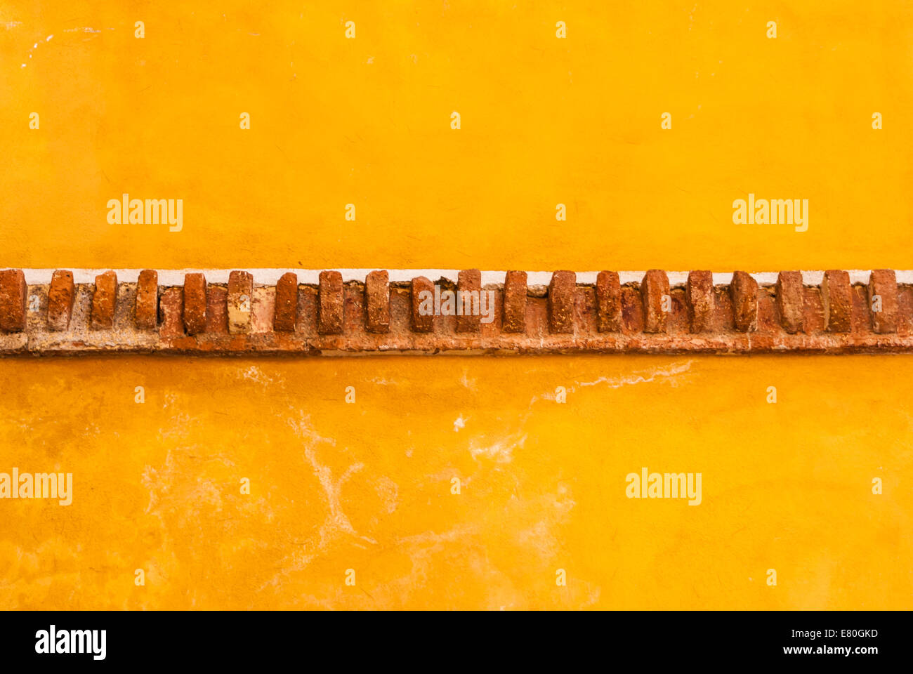 Yellow adobe wall with brick trim Guanajuato Mexico Stock Photo - Alamy