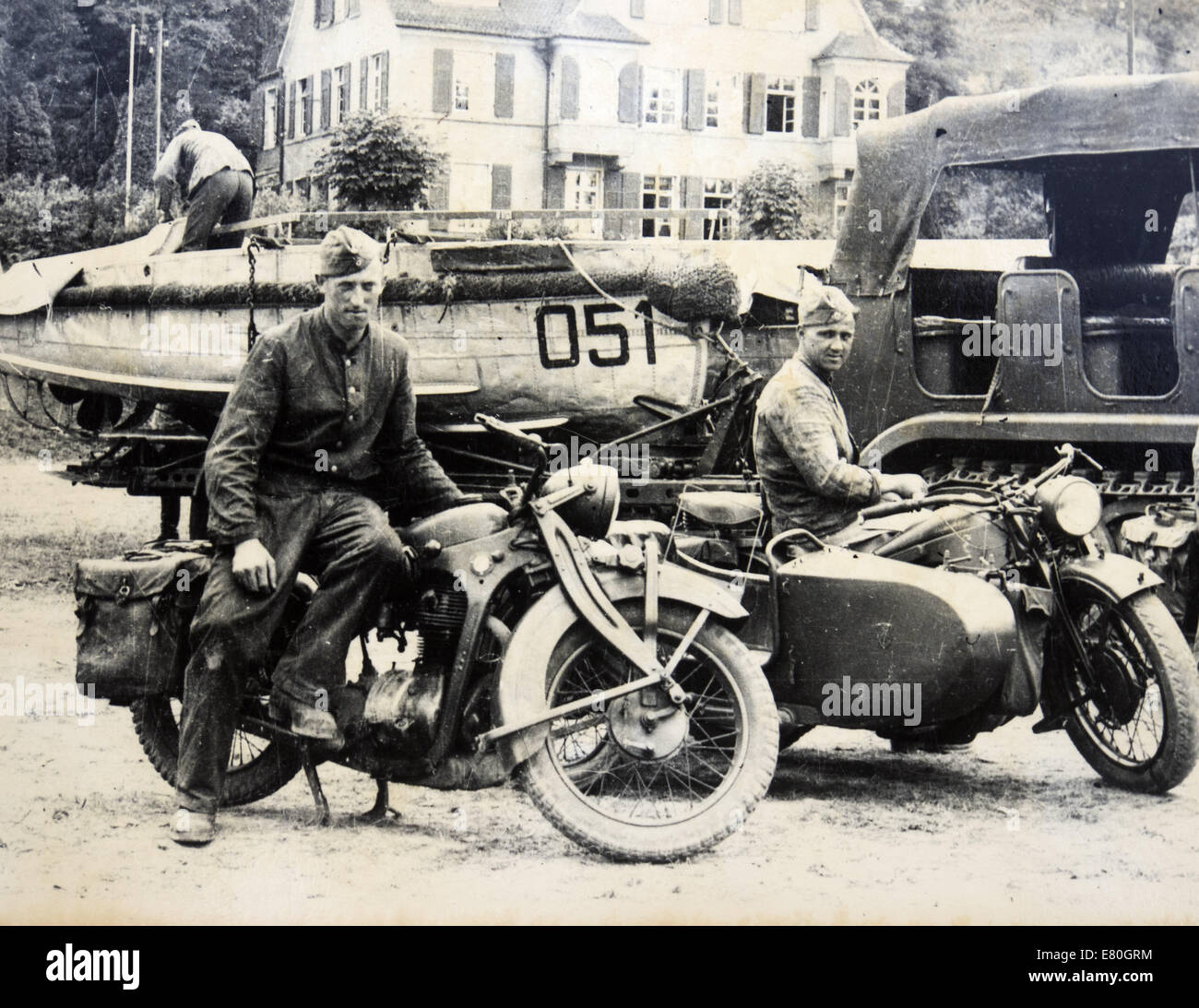 German soldiers posing on a motorcycle, Germany, 1940s. Reproduction of ...