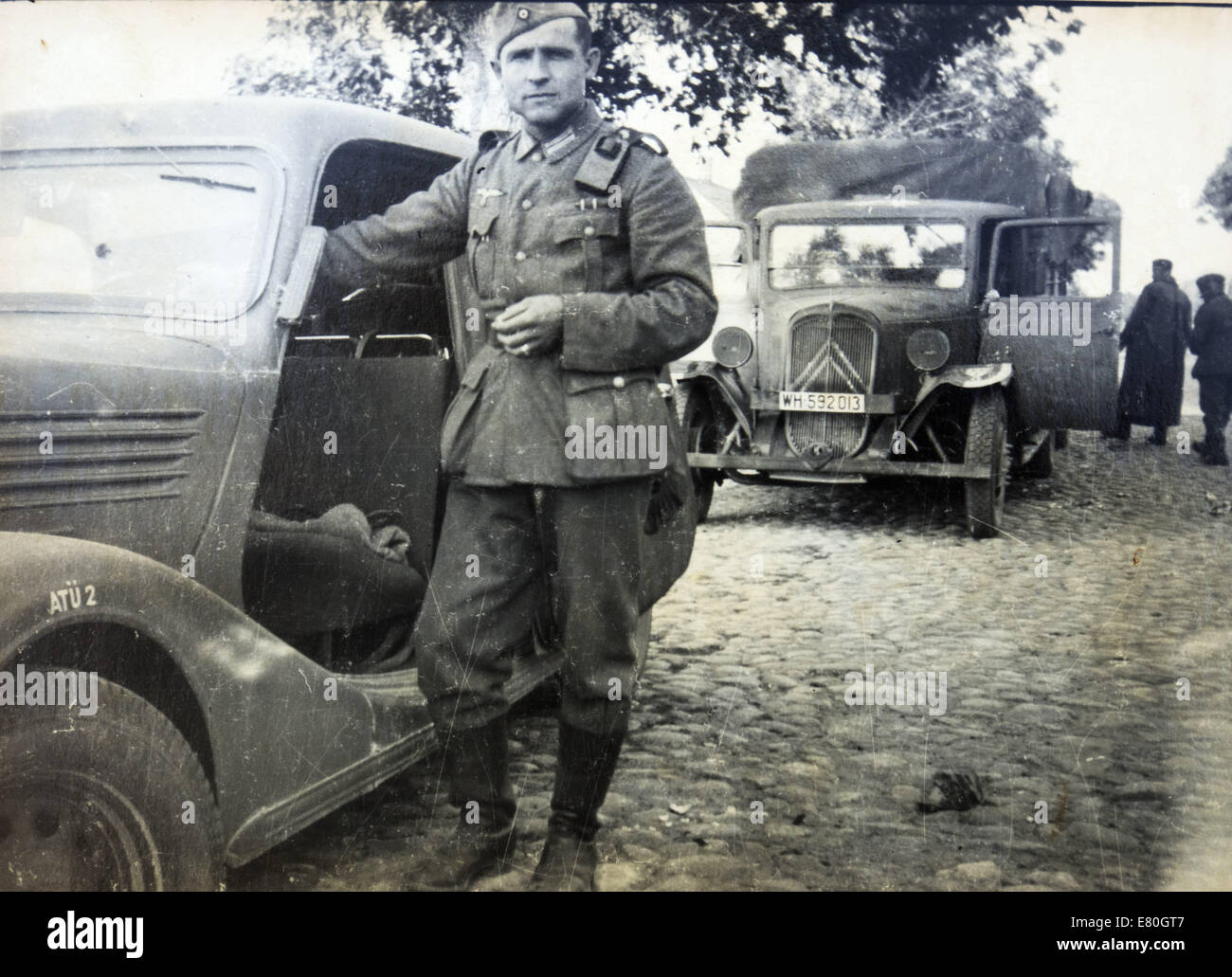 German soldiers posing near the car, Germany, 1940s. Reproduction of ...