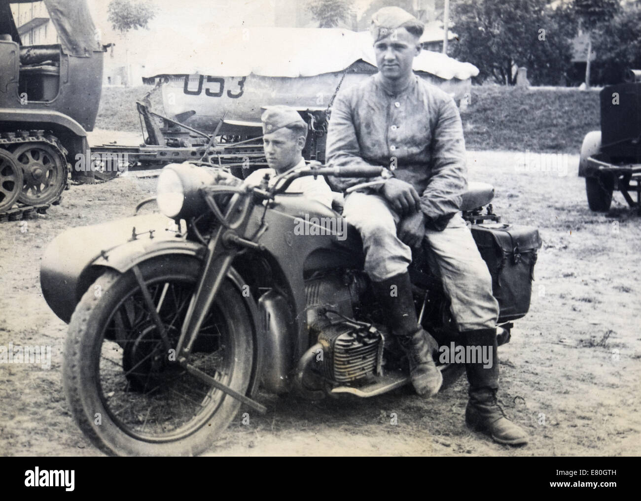 German soldiers posing on a motorcycle, Germany, 1940s. Reproduction of ...