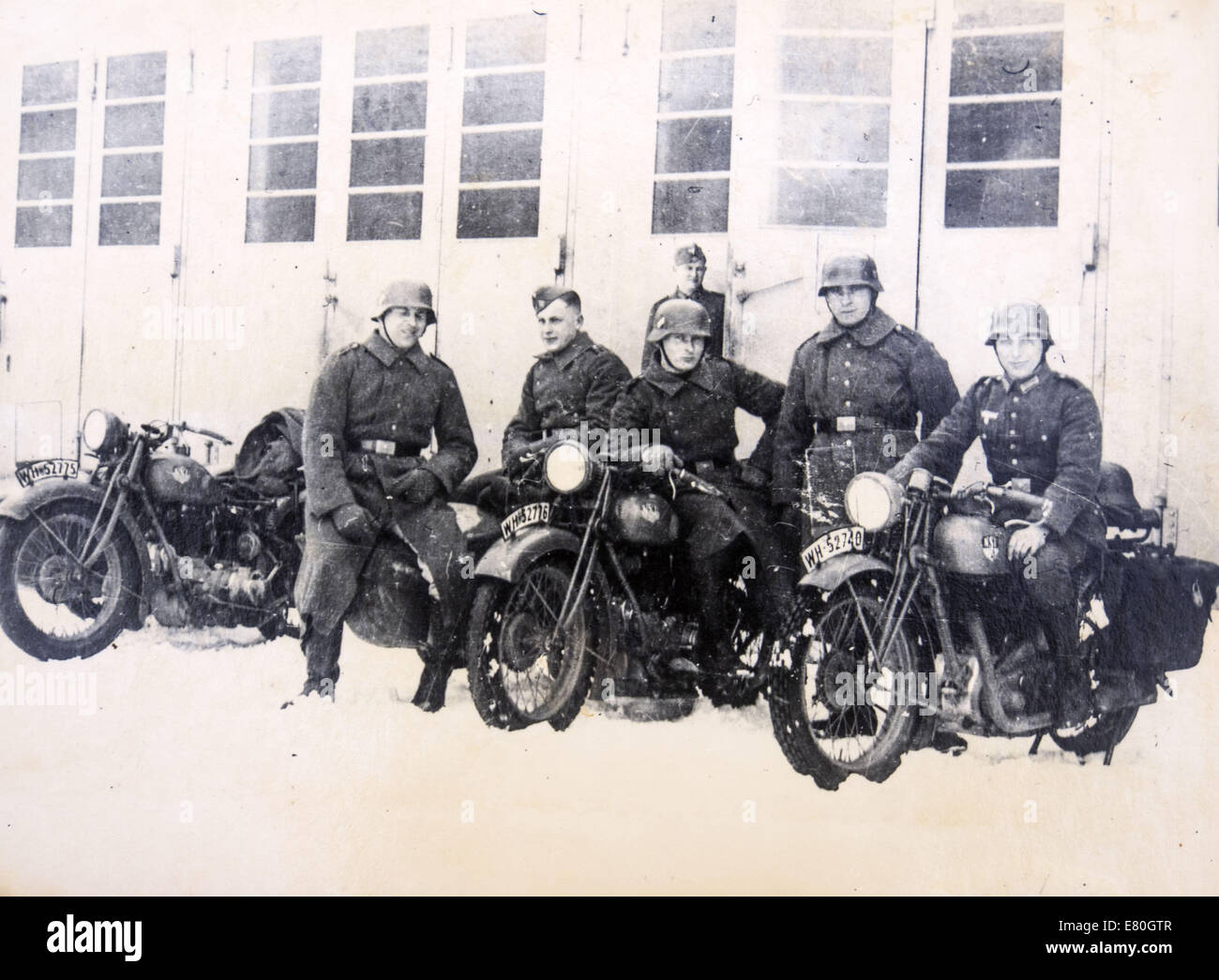 German soldiers posing on a motorcycle, Germany, 1940s. Reproduction of ...