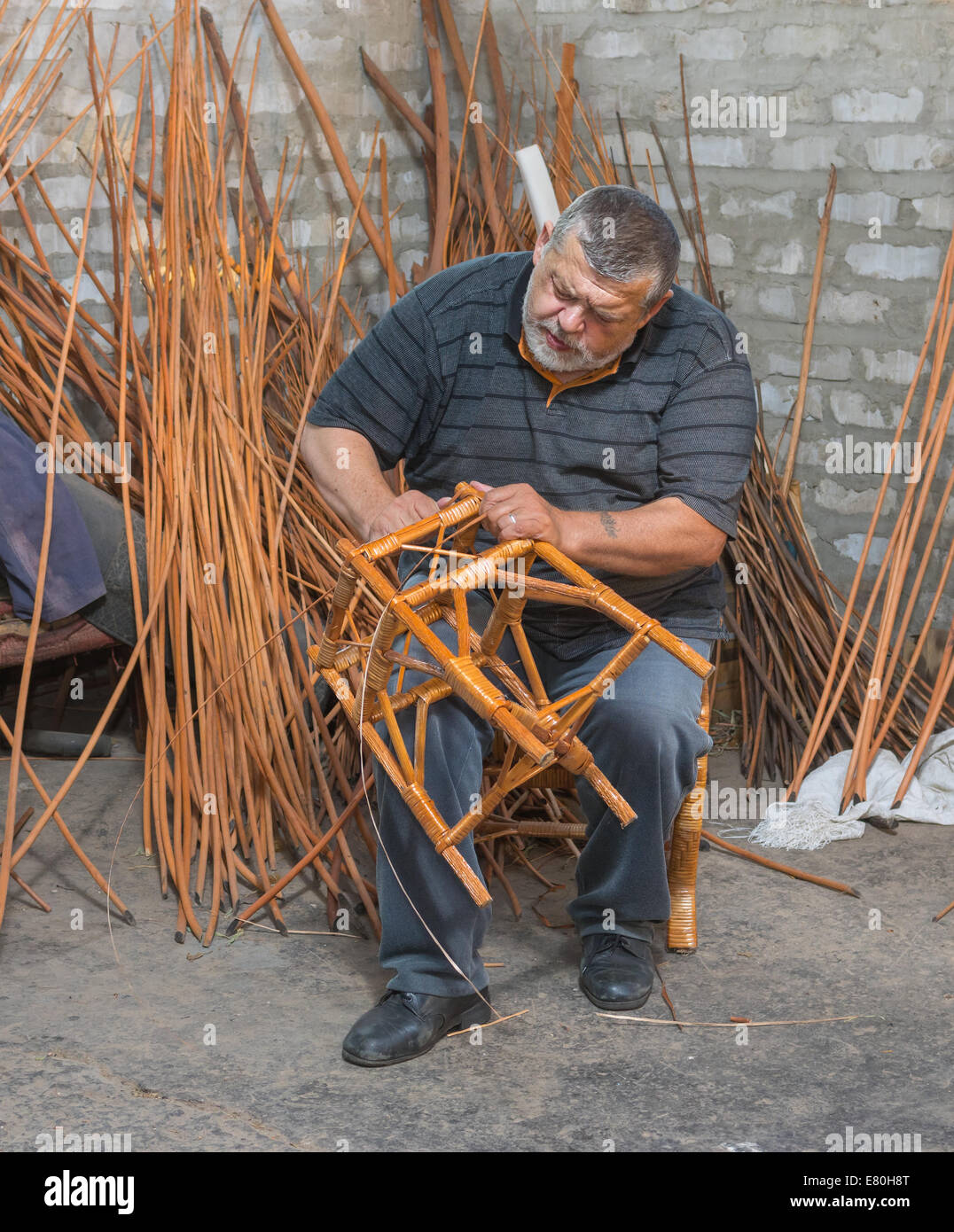 Master of wicker-work making a stool Stock Photo - Alamy