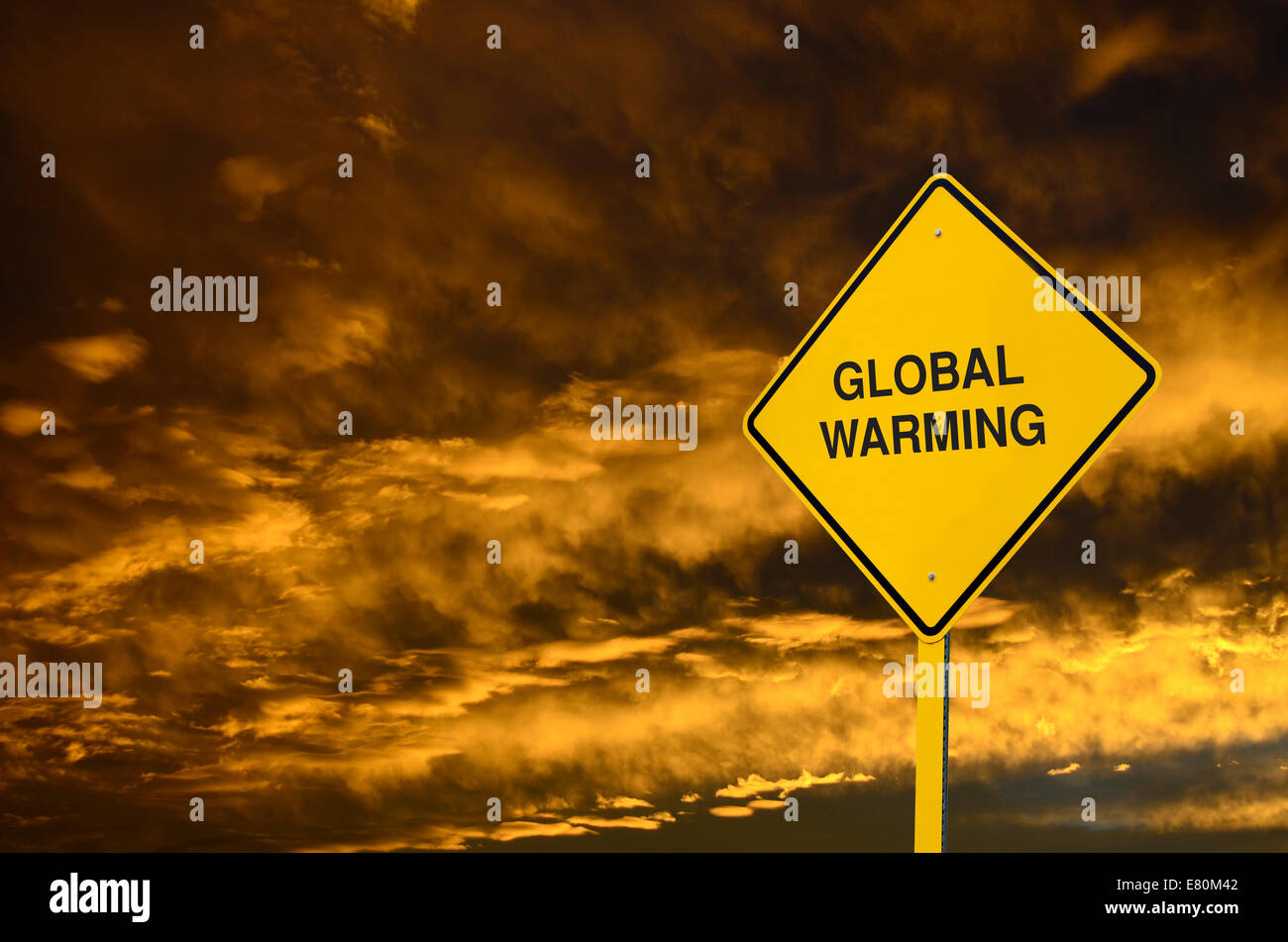 A Caution Sign in front of dramatic yellow storm clouds warning of ...