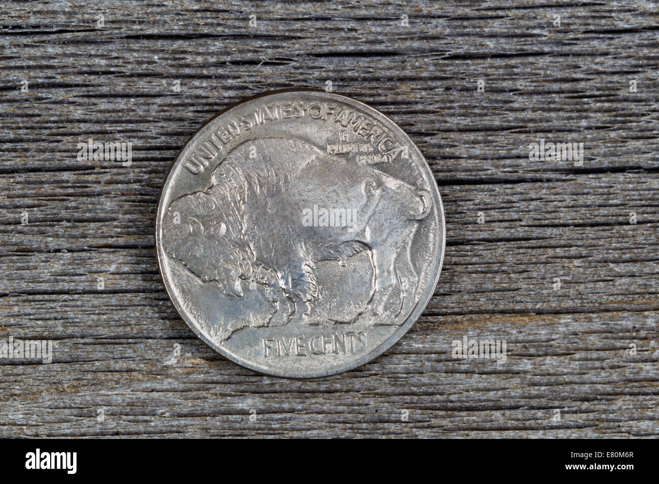 Closeup image of American Buffalo Nickel, reverse side, on rustic wood ...