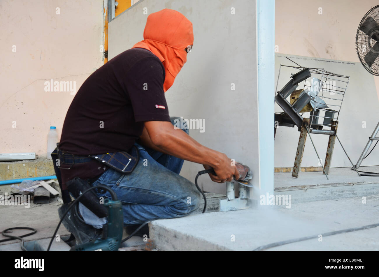 Man use cutting machine cut smartboard Stock Photo - Alamy
