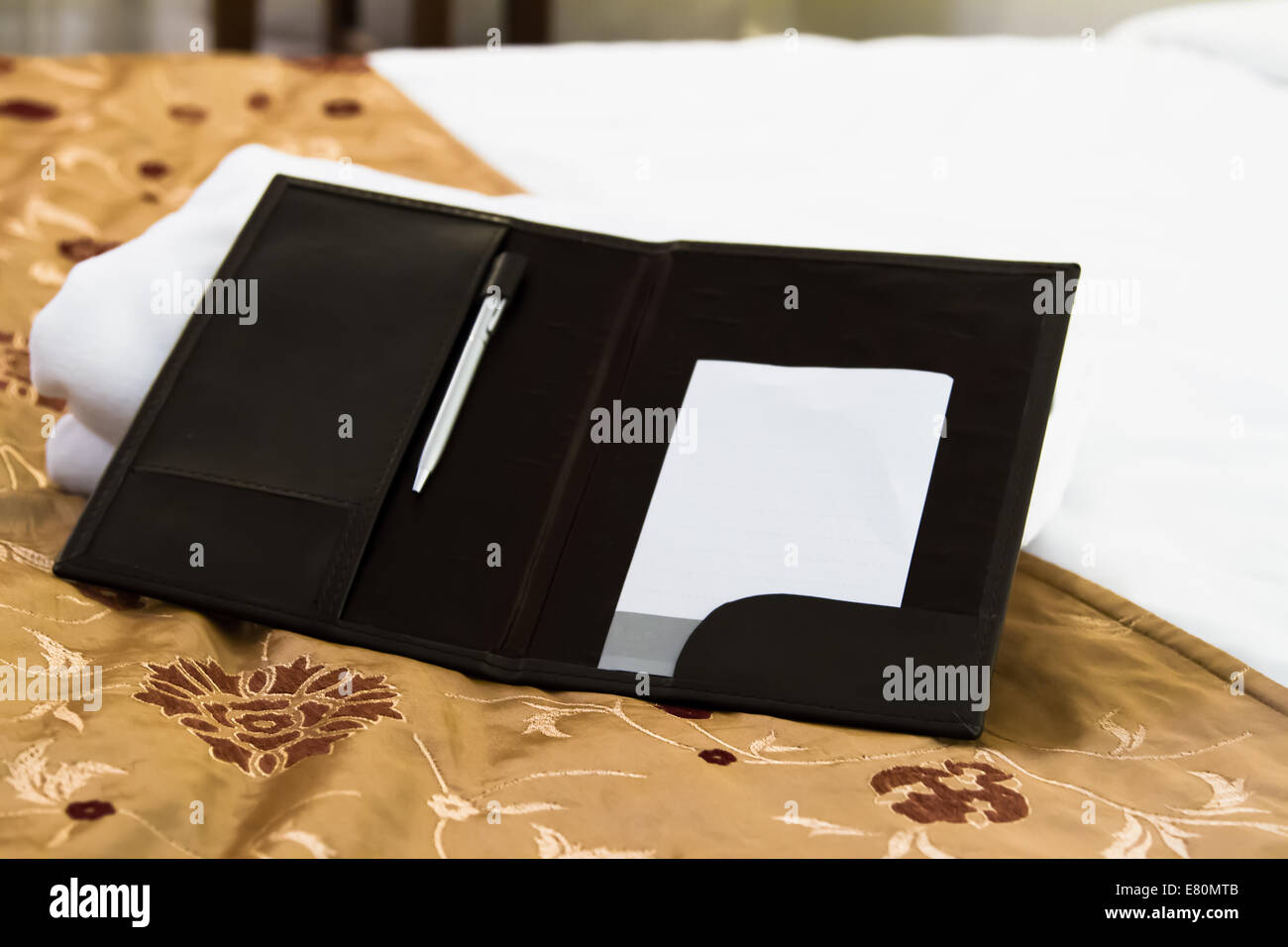 White blank note with pen on bed in hotel room Stock Photo - Alamy