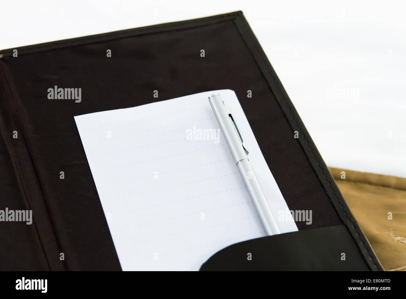 White blank note with pen on bed in hotel room Stock Photo - Alamy