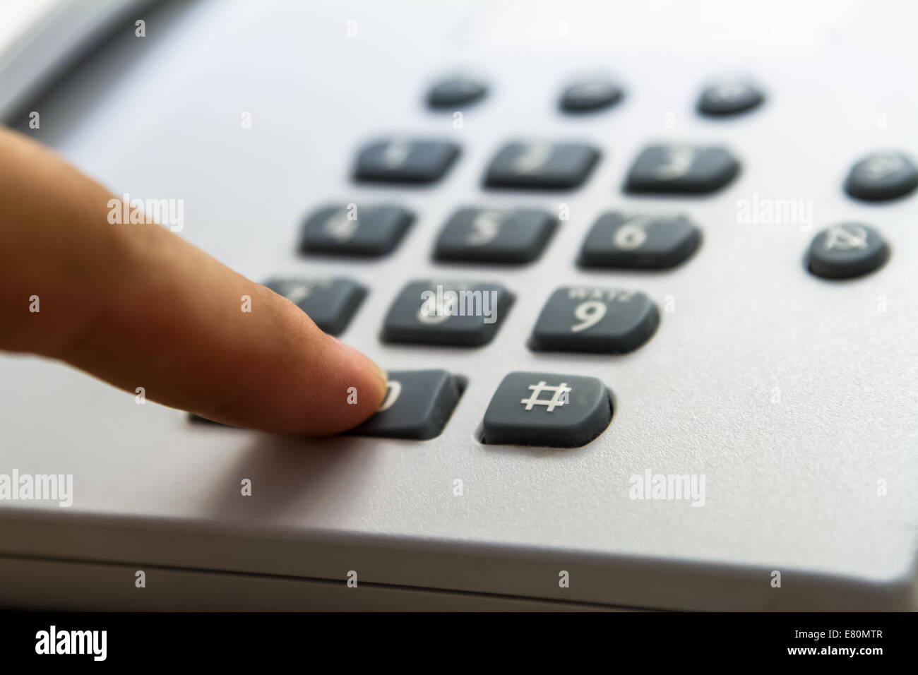 Finger pressing phone key, telephone for customer service in hotel room ...