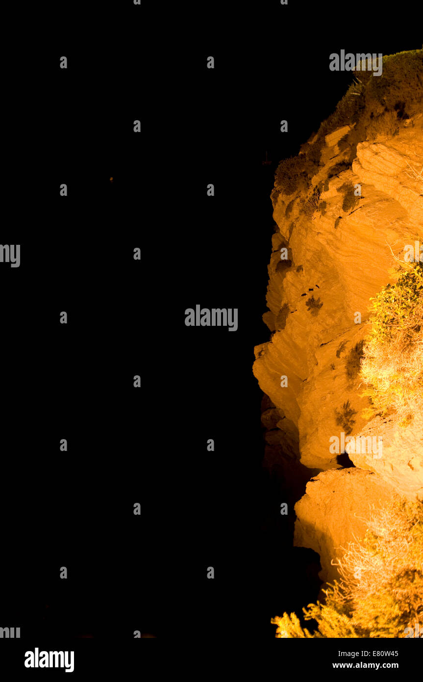 Enlightened rocks from a cliff in the night Stock Photo - Alamy