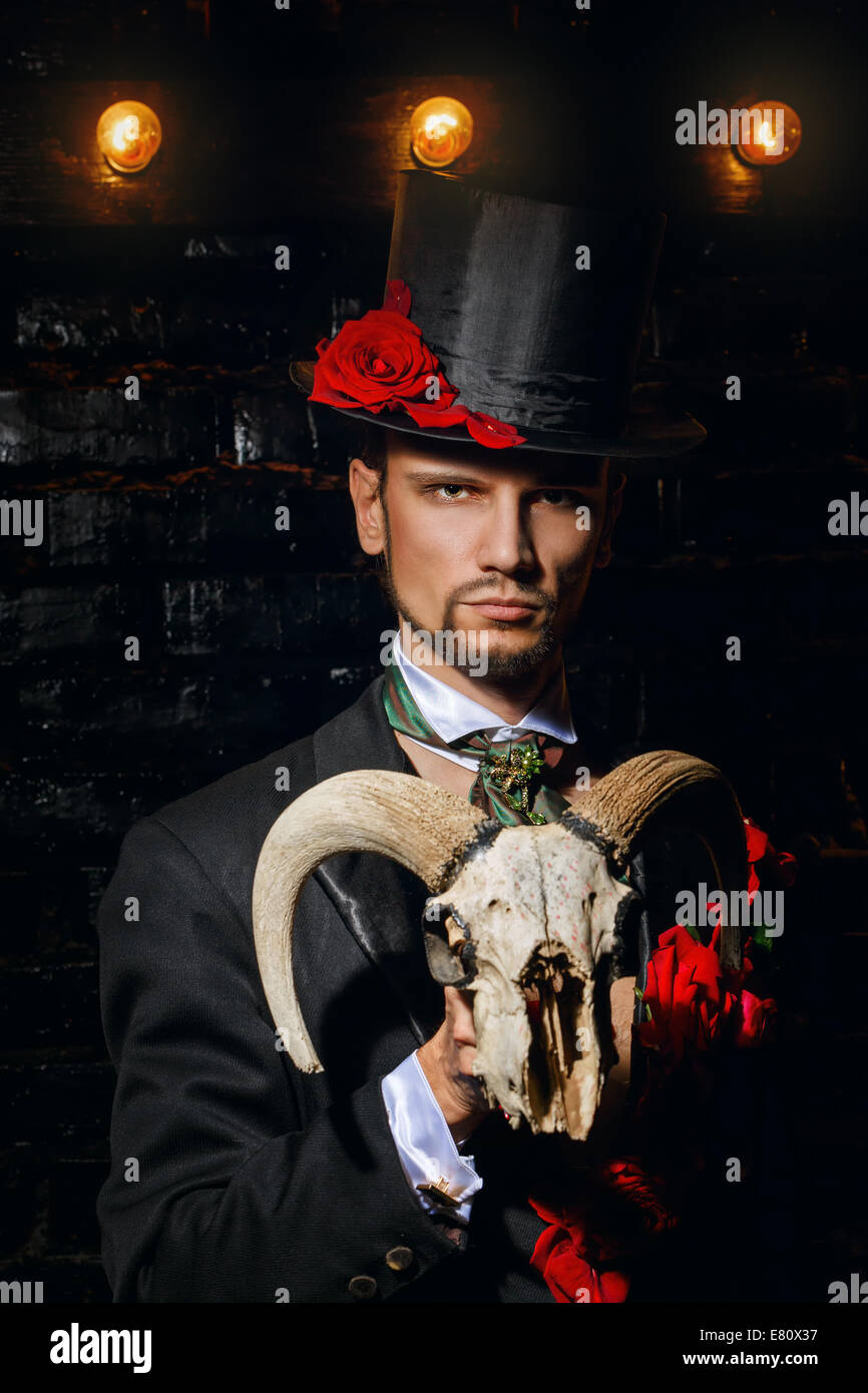 The young man is wizard holds the old goat skull Stock Photo - Alamy