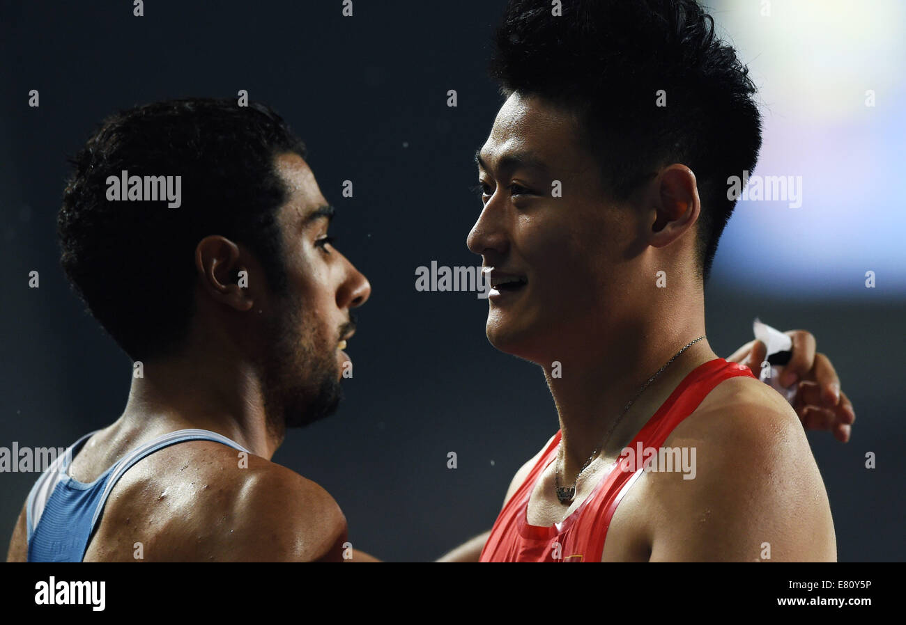 Incheon, South Korea. 28th Sep, 2014. Jiang Fan (R) of China receives ...