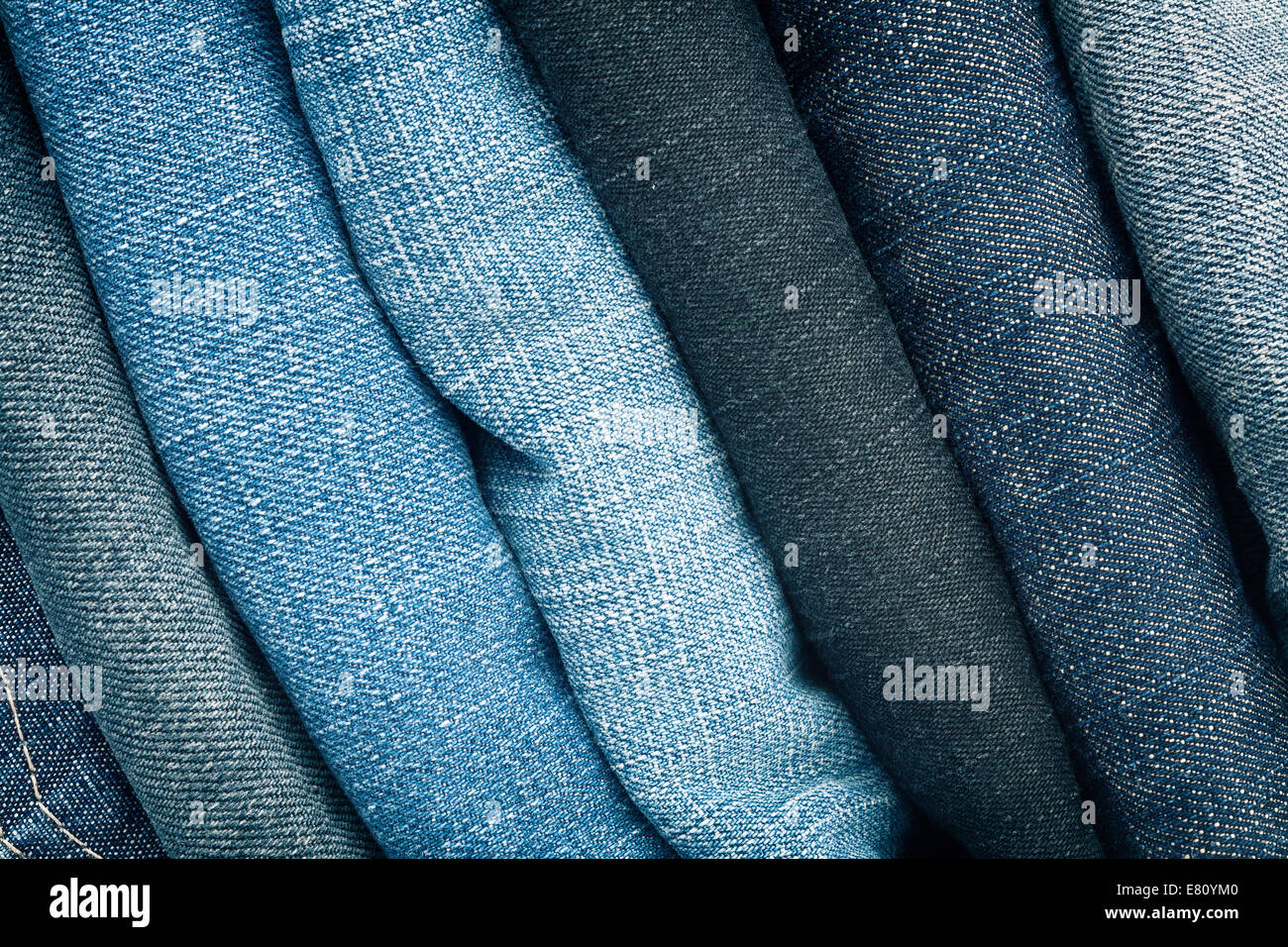Stack of blue jeans as a background or texture Stock Photo - Alamy