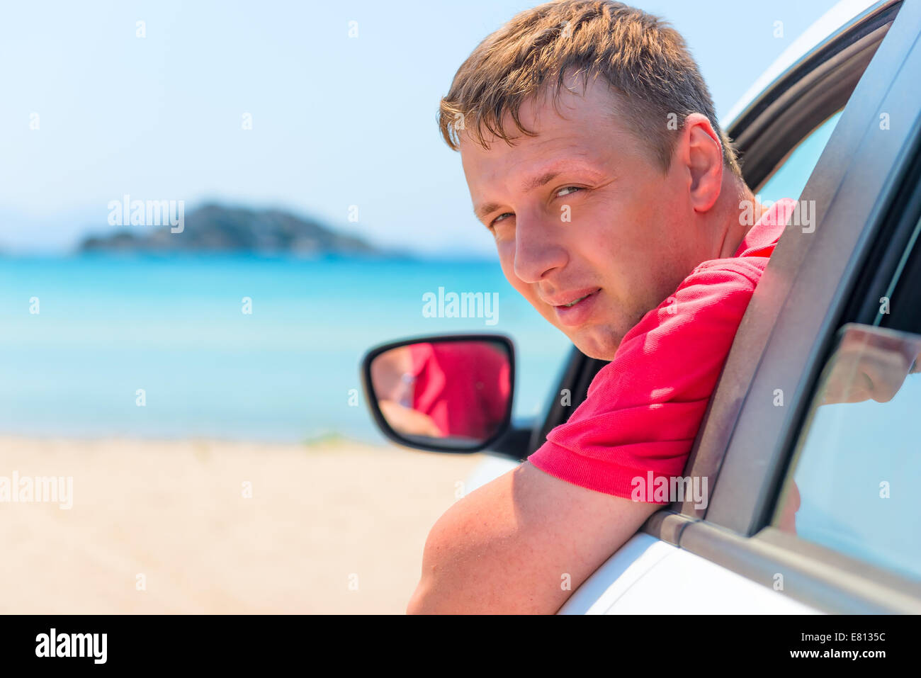 handsome man looking out the window of the car, shot near the sea Stock ...