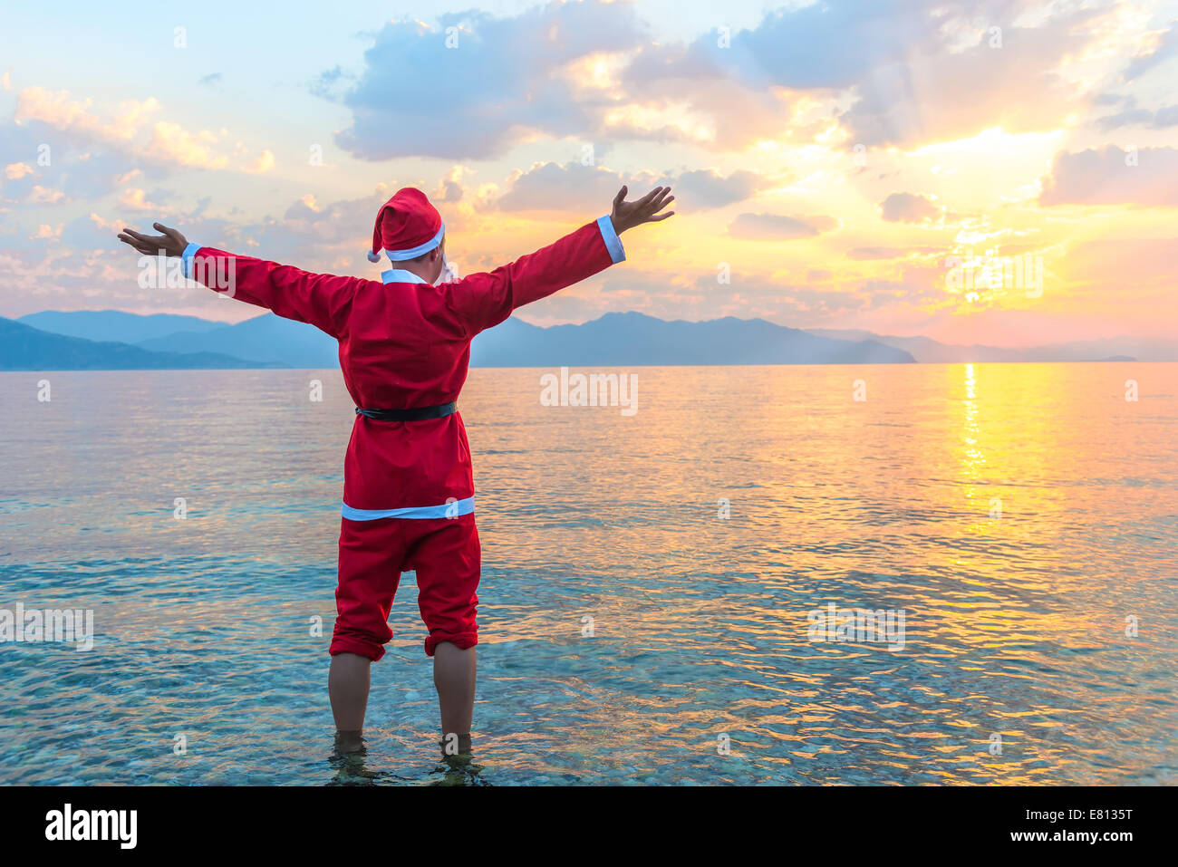 Santa Claus standing barefoot in the sea Stock Photo - Alamy