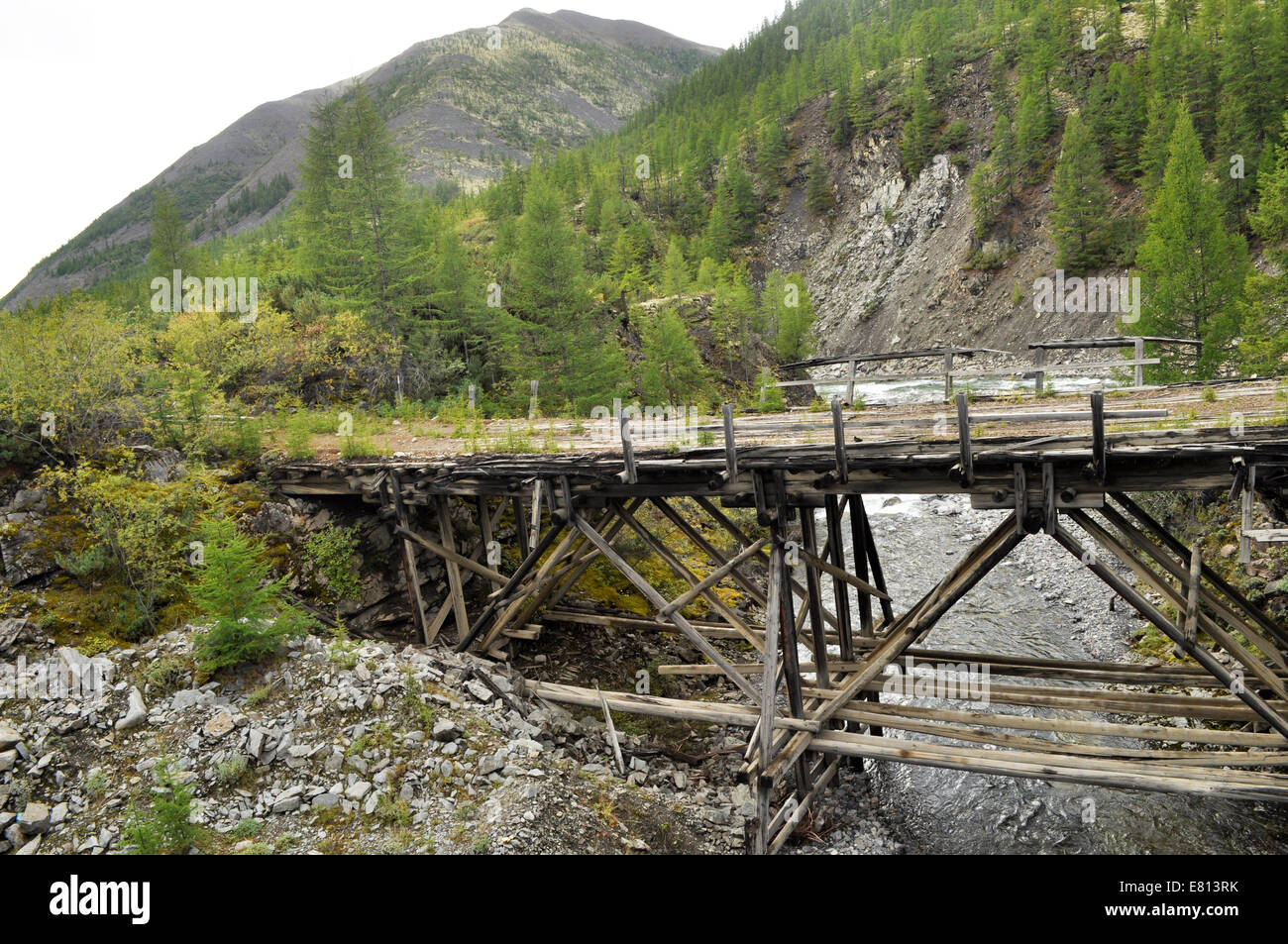 The old bridge in the mountains. Mountain river near the highway ...