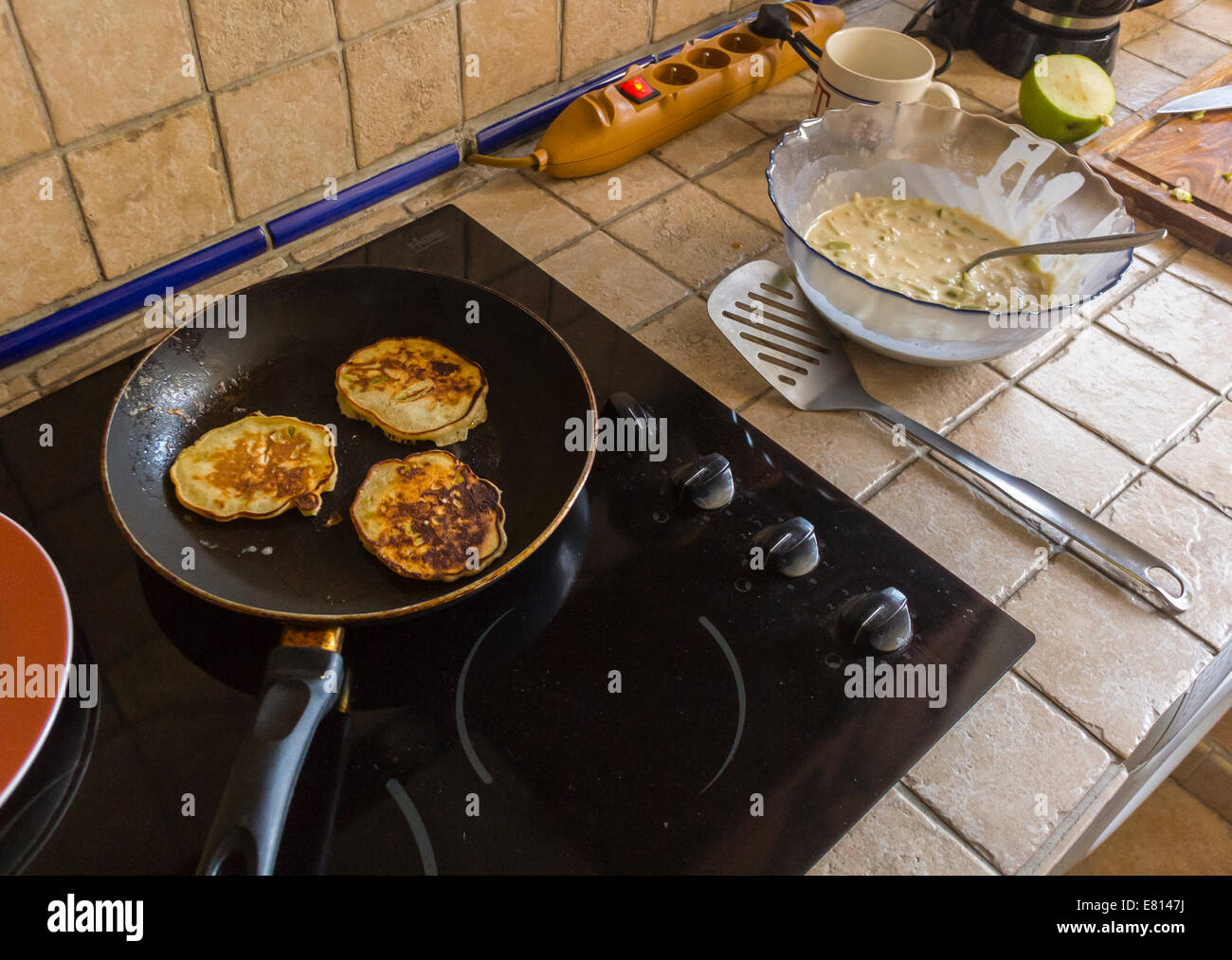 Pancakes being cooked in Pan a Home on Kitchen Stove Stock Photo - Alamy