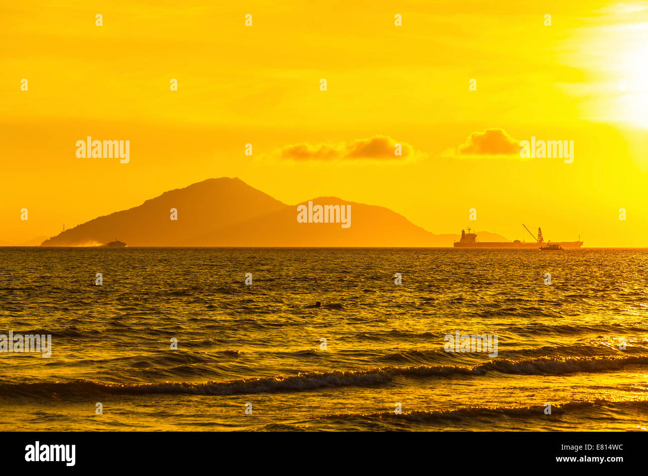 Cargo container ship sailing at the sunset Stock Photo - Alamy