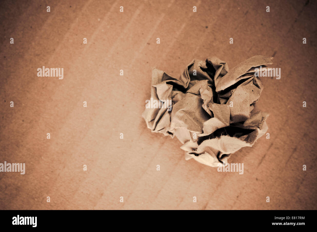 balled up recycled paper on a cardboard surface Stock Photo - Alamy