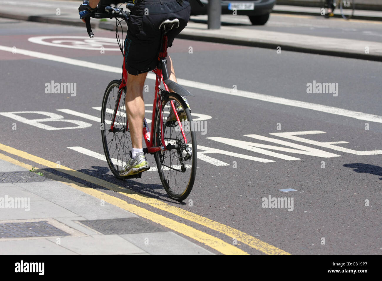 A cyclist riding in a London bus lane Stock Photo - Alamy