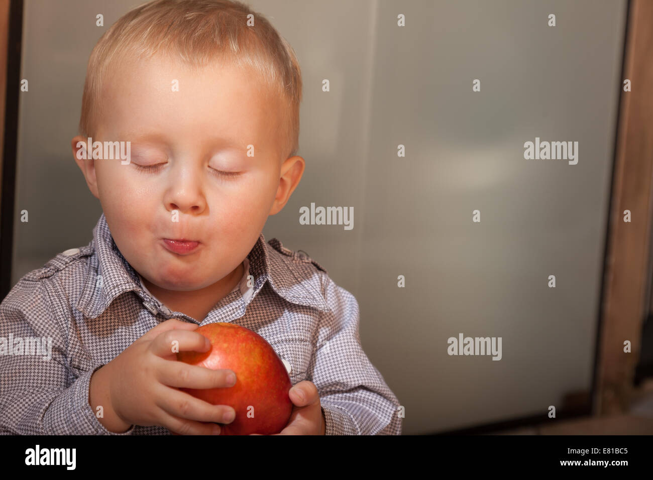 Happy childhood. Portrait of cute little boy child kid eating apple ...