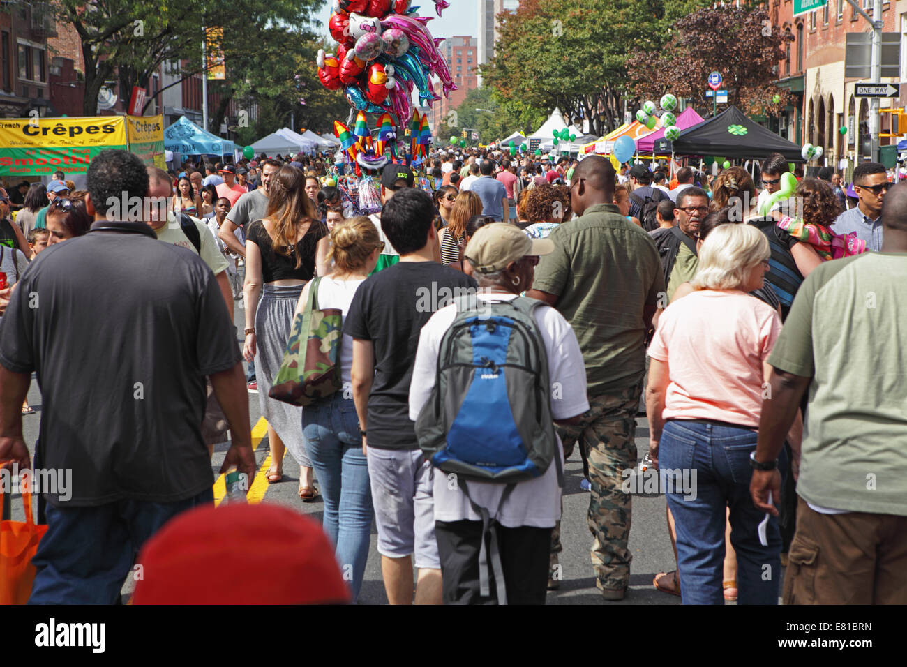 View of people's legs walking along Atlantic Antic Street Fair which is ...