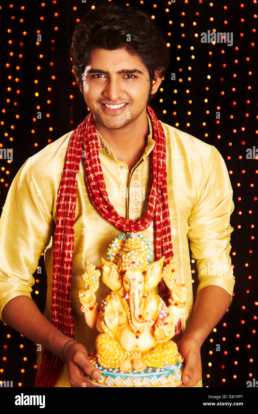 indian Man diwali Festival standing Ganpati Statue Stock Photo - Alamy