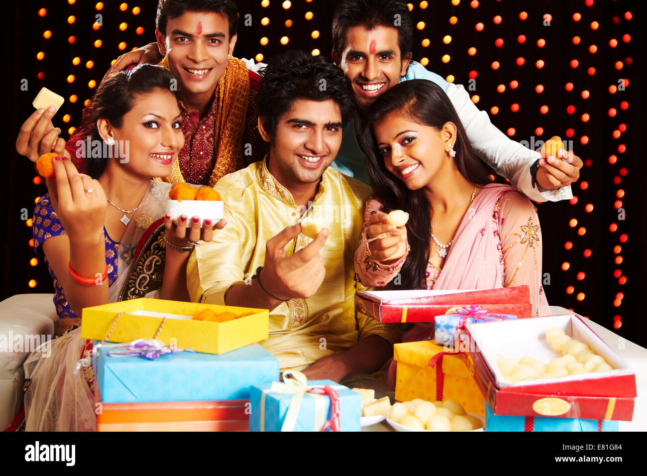 indian friends diwali Eating Sweets Stock Photo - Alamy