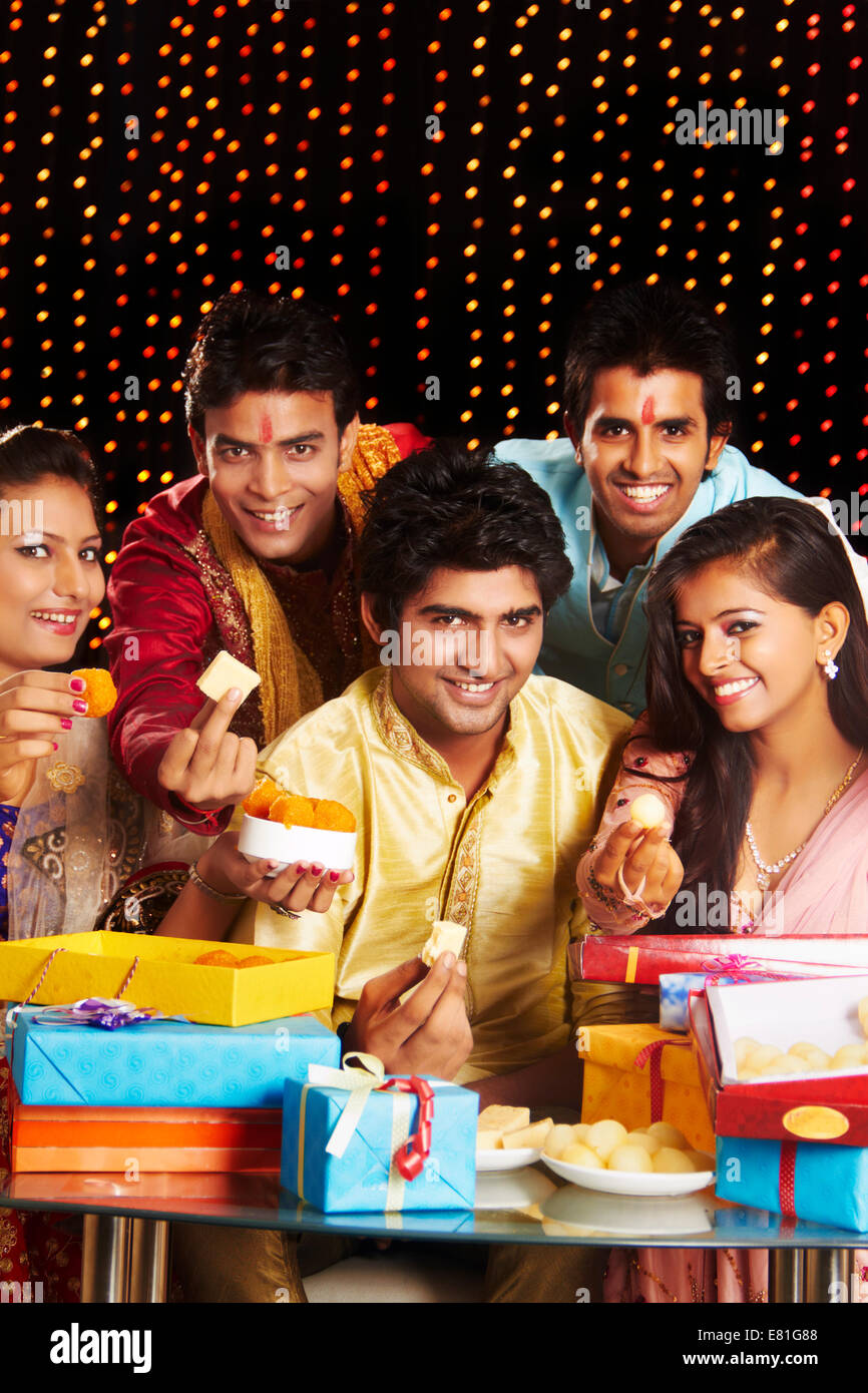indian friends diwali Eating Sweets Stock Photo - Alamy