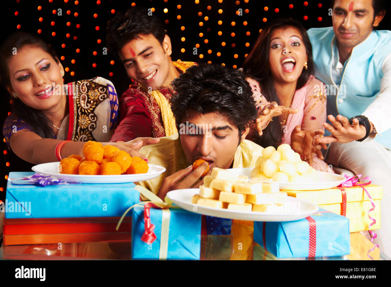 indian friends diwali Eating Sweets Stock Photo - Alamy