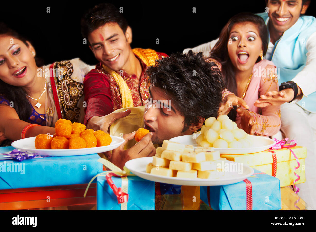 indian friends diwali Eating Sweets Stock Photo - Alamy