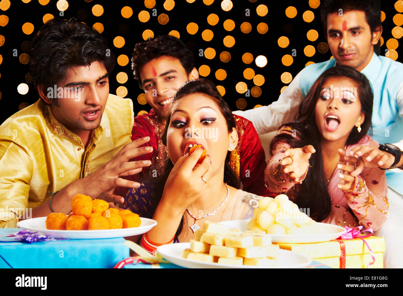 indian friends diwali Eating Sweets Stock Photo - Alamy