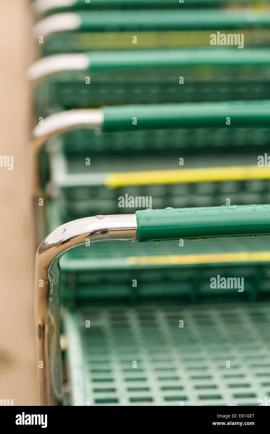 Large green shopping cart in a row Stock Photo - Alamy
