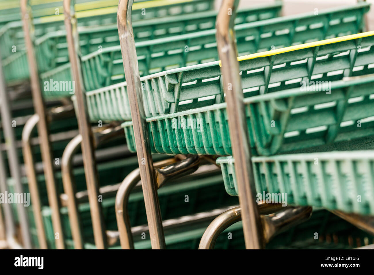 Large green shopping cart in a row Stock Photo - Alamy