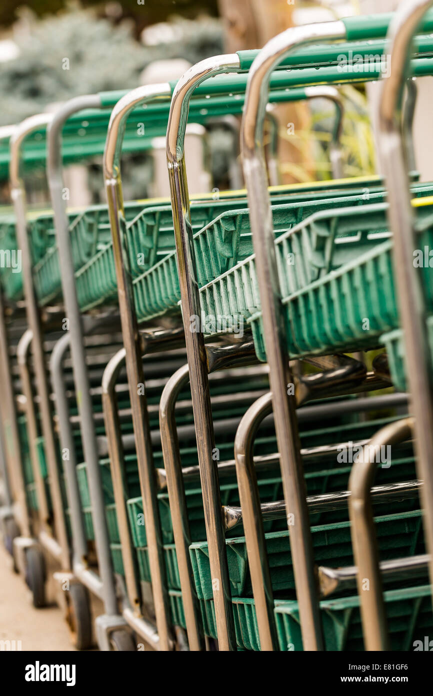 Large green shopping cart in a row Stock Photo - Alamy
