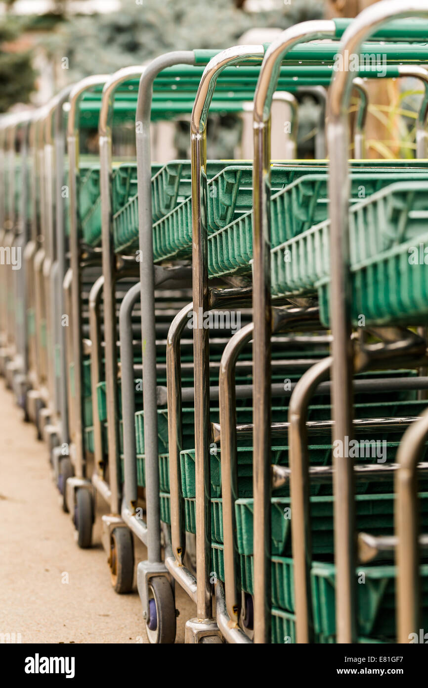 Large green shopping cart in a row Stock Photo - Alamy