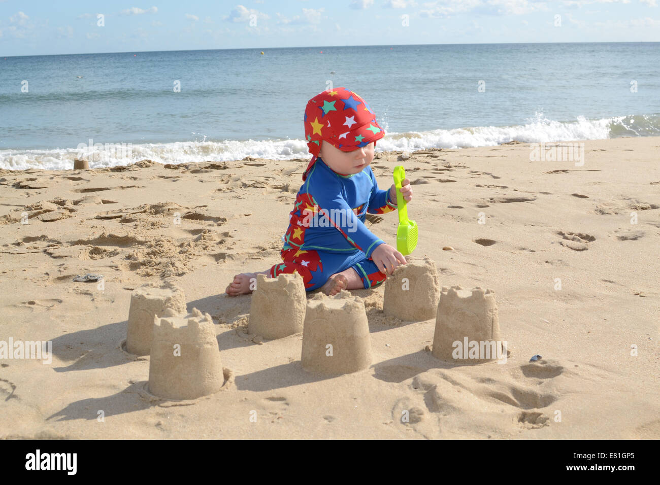 Young boy building sand castle on the beach Stock Photo - Alamy
