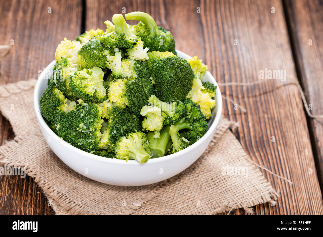 Bowl with Cooked Broccoli (close-up shot) on wooden background Stock ...