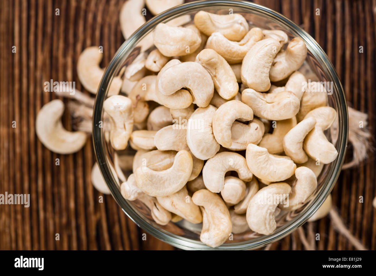 Dried Cashew Nuts on wooden background (close-up shot Stock Photo - Alamy