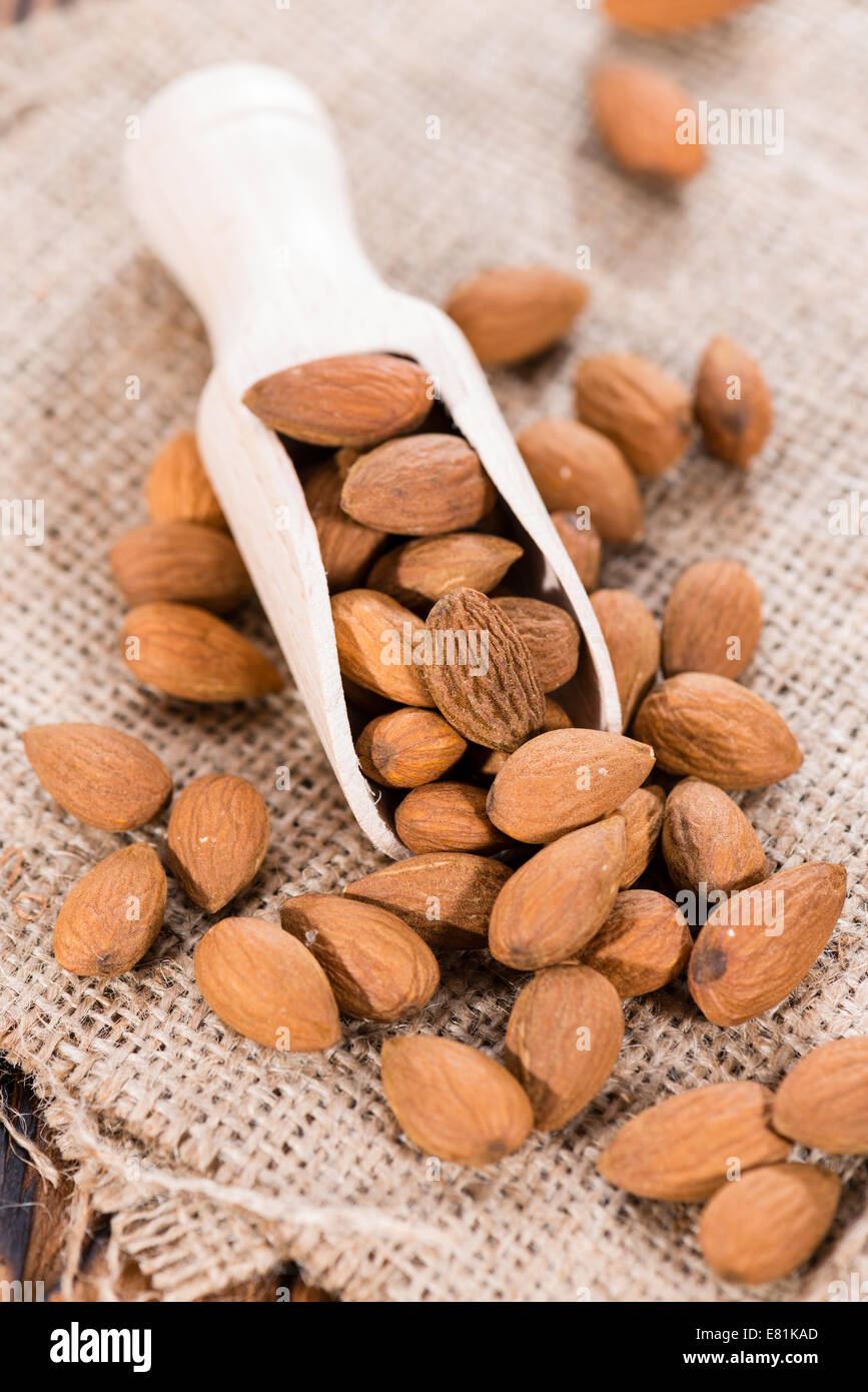 Portion of dried Almonds (close-up shot) on wooden background Stock ...