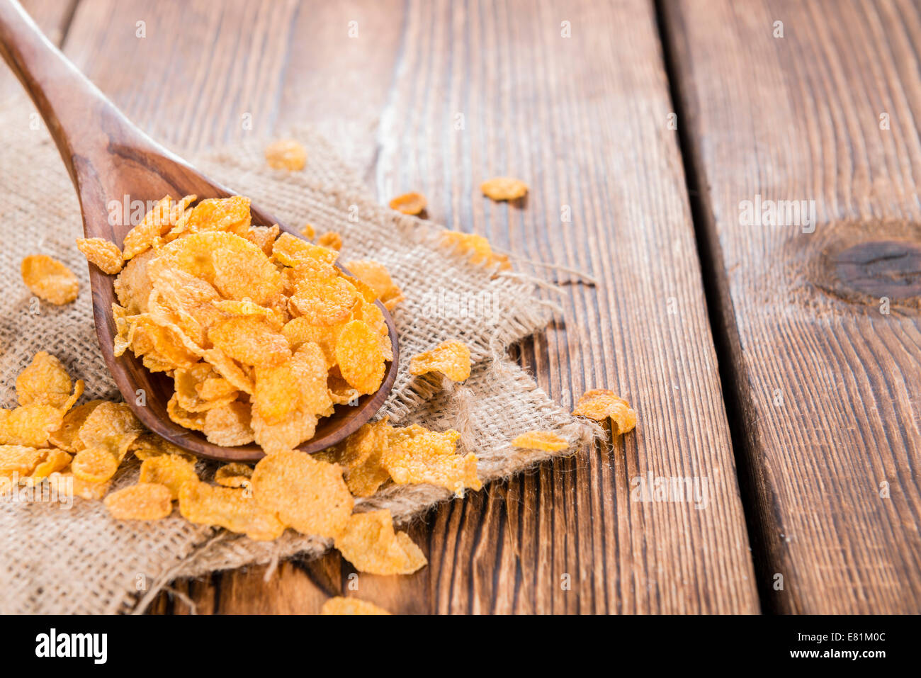 Golden Cornflakes (detailed close-up shot) on an old wooden table Stock ...