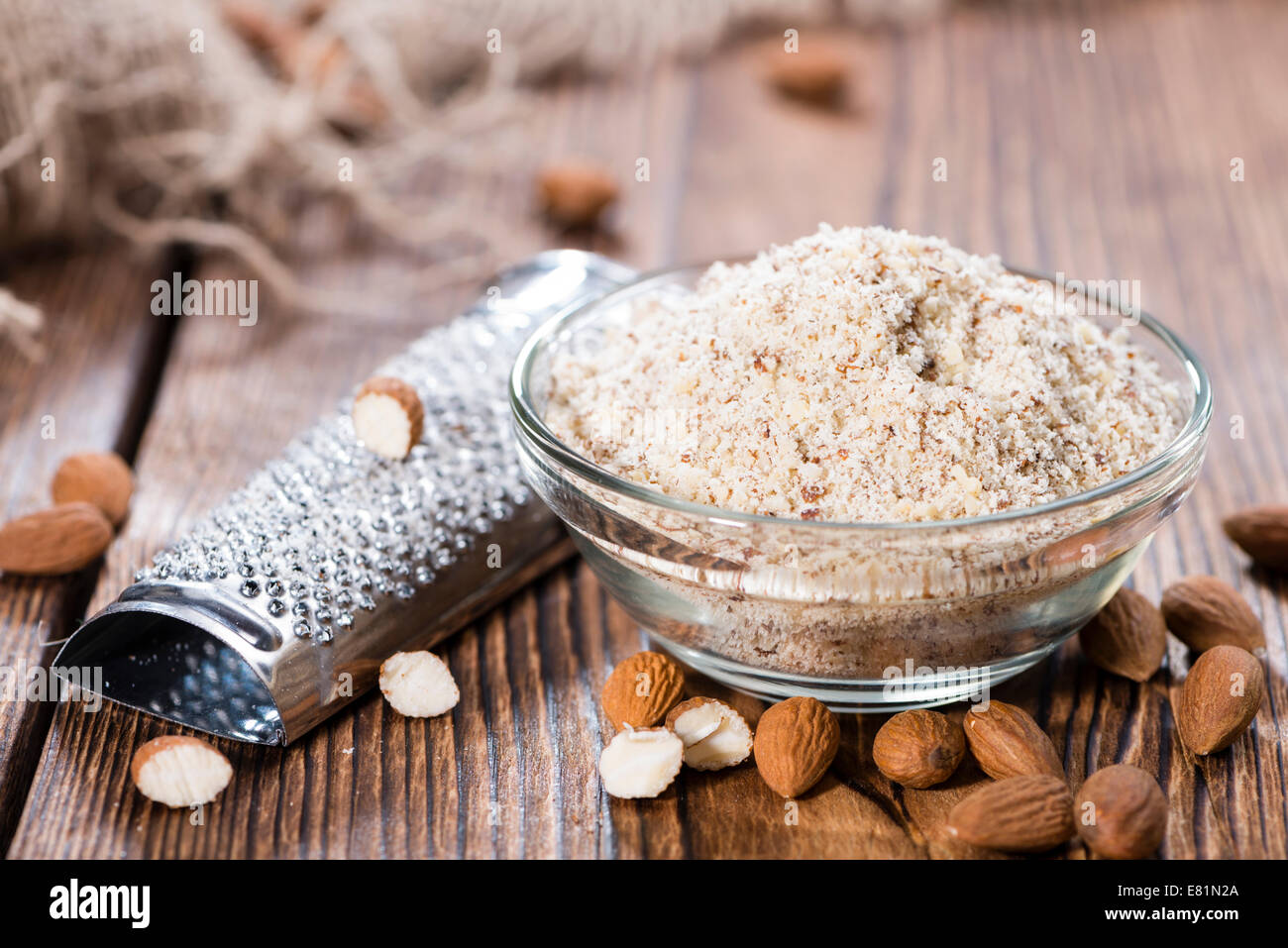 Portion of fresh grated Almonds on wooden background Stock Photo - Alamy
