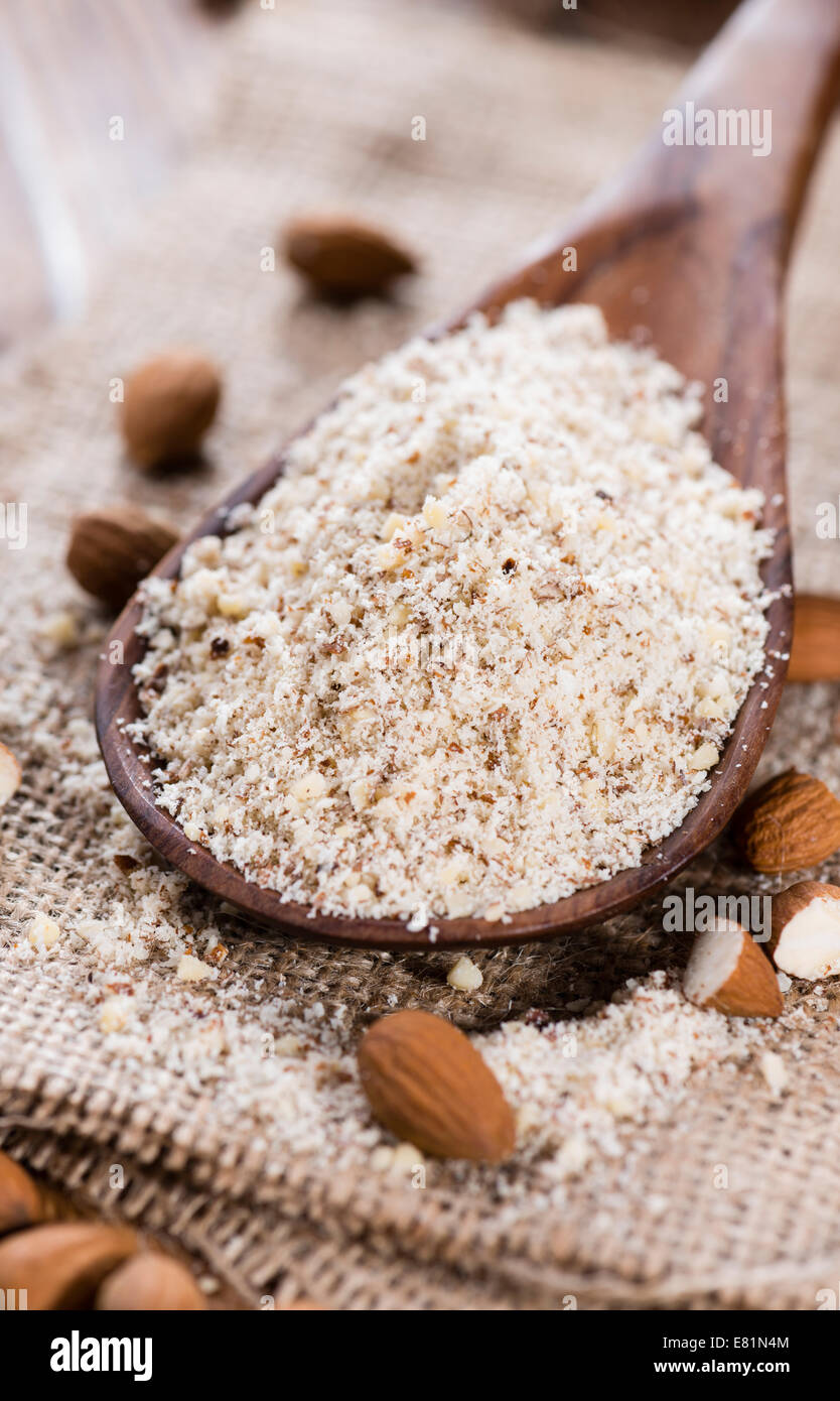 Portion of grated Almonds (detailed close-up shot on wooden background ...