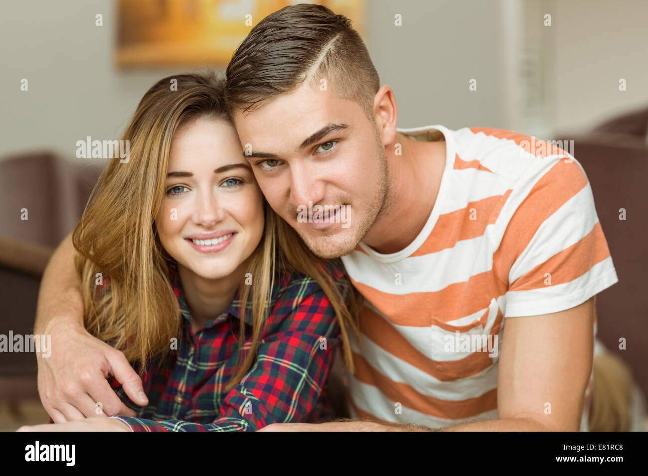 Cute couple smiling at camera Stock Photo - Alamy
