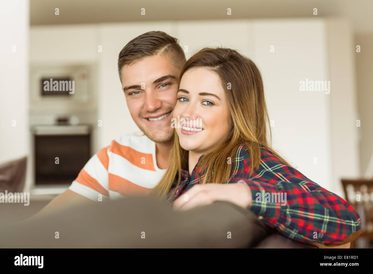 Cute couple relaxing on couch Stock Photo - Alamy